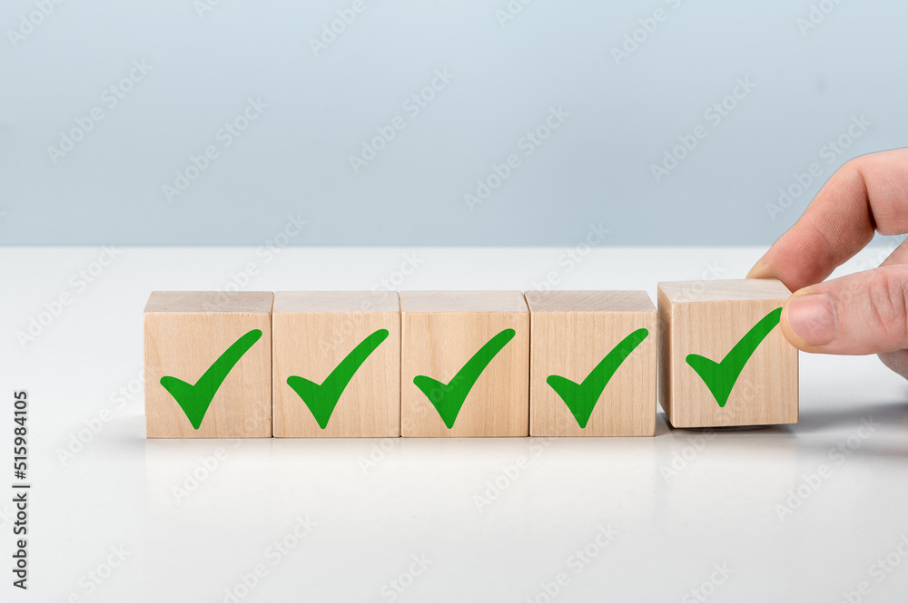 ภาพถ่าย Stock Checklist concept, check mark on wooden blocks on with ...