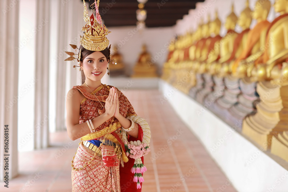 Young fashion and beautiful asian woman in red Thai traditional costume ...