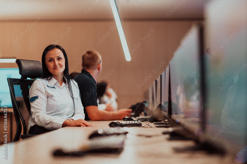 Female security operator working in a data system control room offices Technical Operator ...