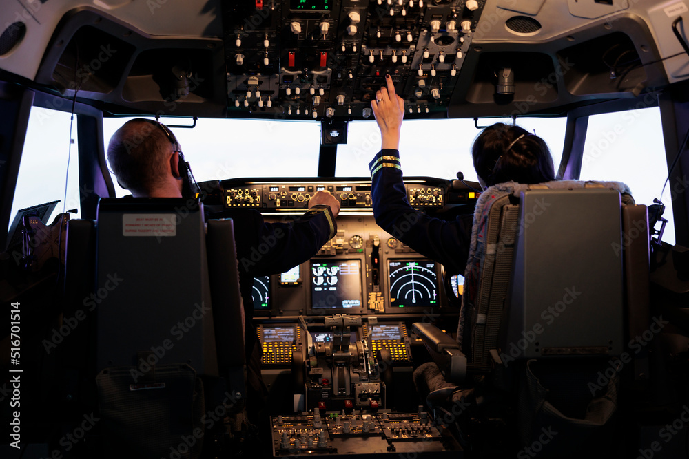 Captain and woman copilot getting ready to fly airplane and takeoff ...