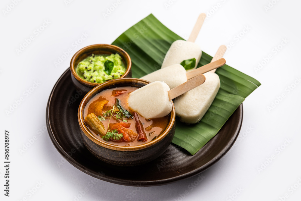 Idly lollipop or idli candy with stick served with sambar and chutney ...
