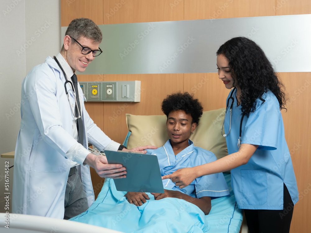 At hospital patient lay on bed doctor and nurse talking showing good ...