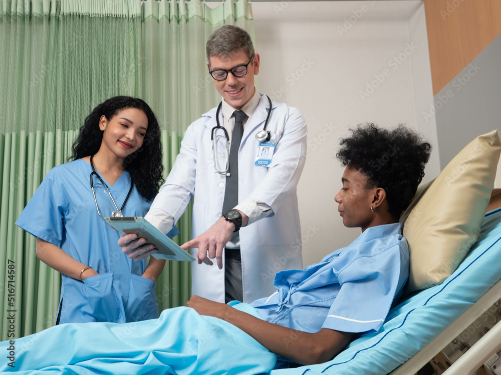 At hospital patient lay on bed doctor and nurse talking showing good ...