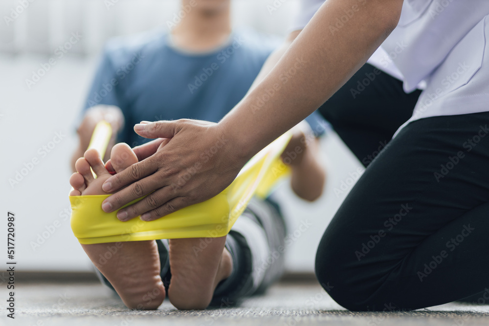 Physical therapists treat patients with exercises using latex therapy ...