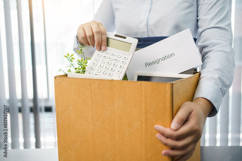 Resignation concept, Female employee packing personal belonging and ...