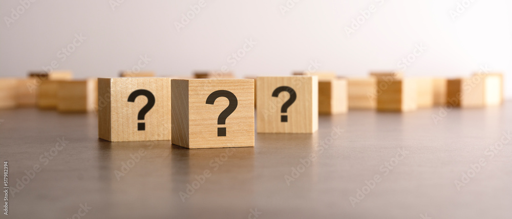 three question marks written on wood blocks Stock Photo | Adobe Stock