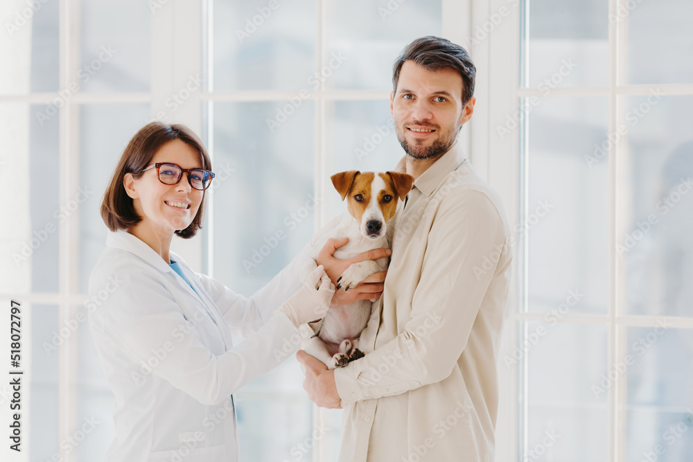 Vet female and male pet owner poses with favourite dog, come to ...