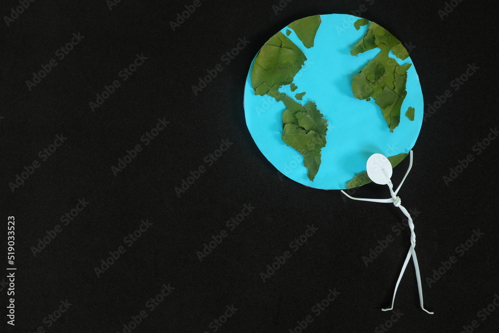 Human stick figure man carrying the earth on his shoulders on dark ...