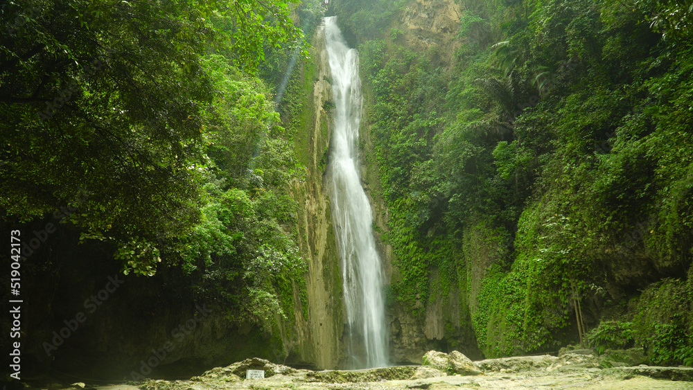 Waterfall in the rainforest jungle. Tropical Mantayupan Falls in ...