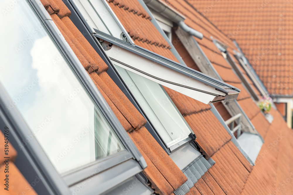 Open ventilation waterproof rooftop window exterior against sunny sky ...