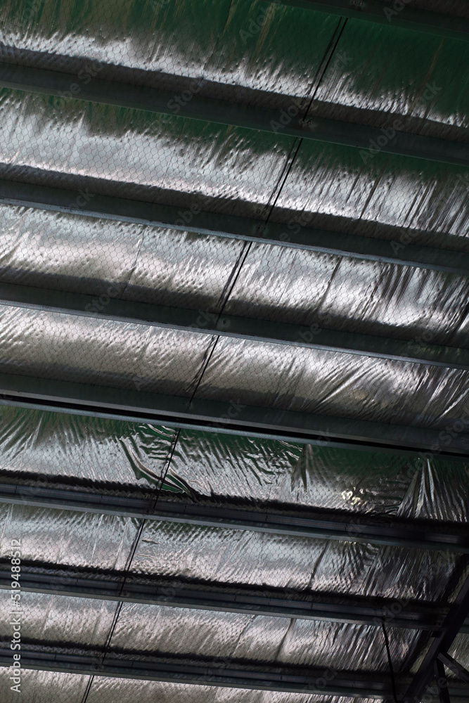 Ceiling view of the metal sheet roof with heat prevention materials ...