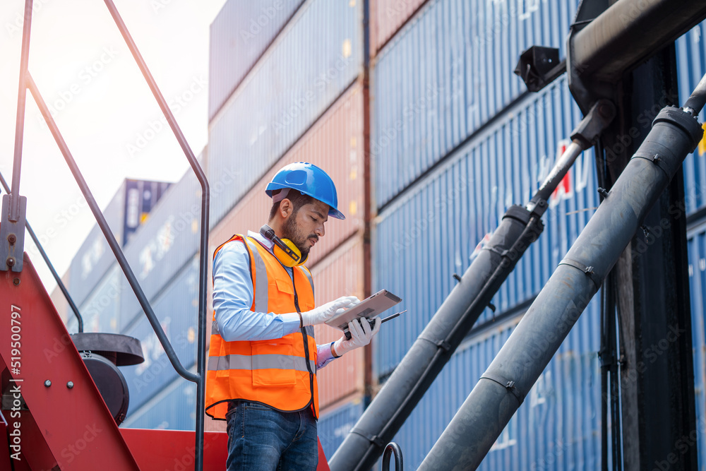 Supervisor dock cargo checking and control loading Containers box at ...