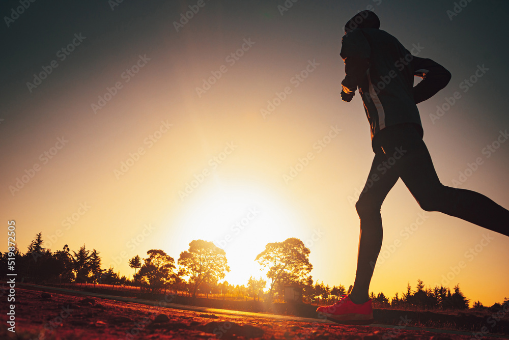 Silhouette of a Kenyan runner at sunrise. Photo from marathon training ...