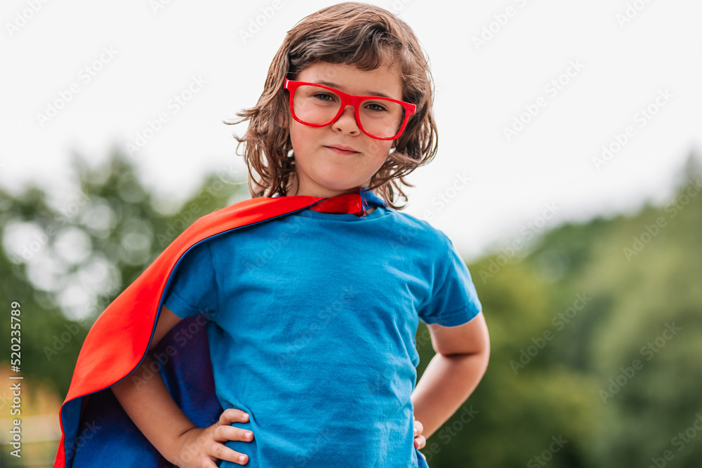 Little superhero with flying cape Stock Photo | Adobe Stock