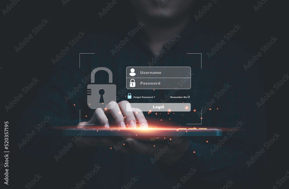 Businessman typing on keyboard laptop computer to input username and password for technology ...