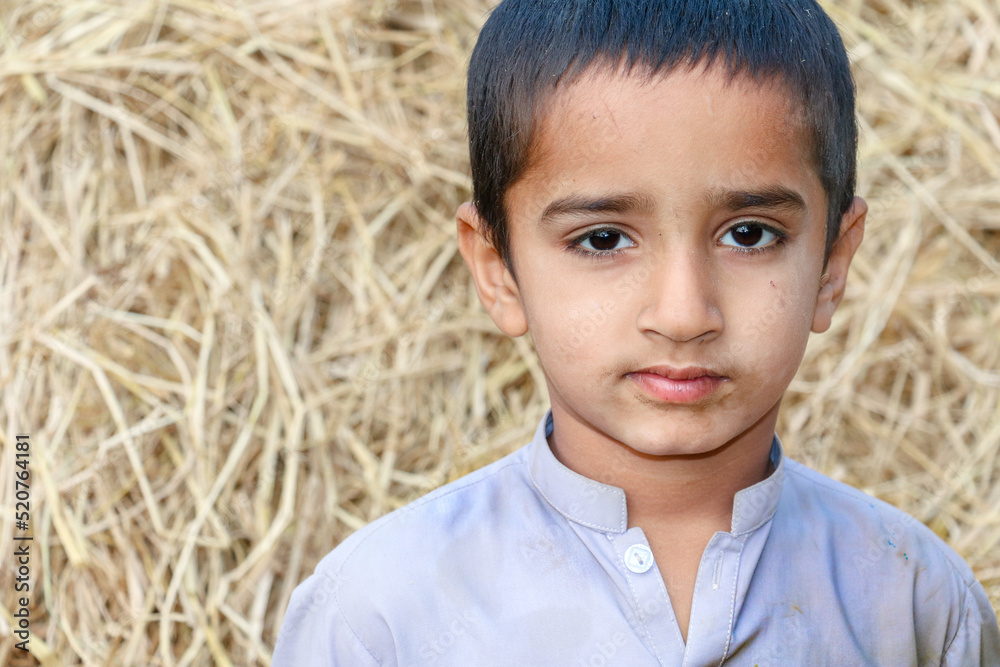 Homeless cute boy in white Asian clothes young child with a sad face ...