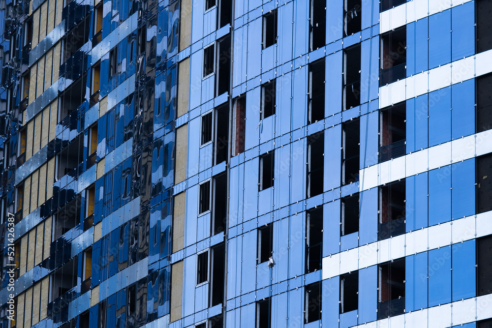 Facing the building with a ventilated facade. Aluminum colored facades. Modern facades of high ...