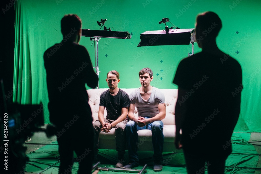 Professional male actors work in the frame on the set. Shooting with ...