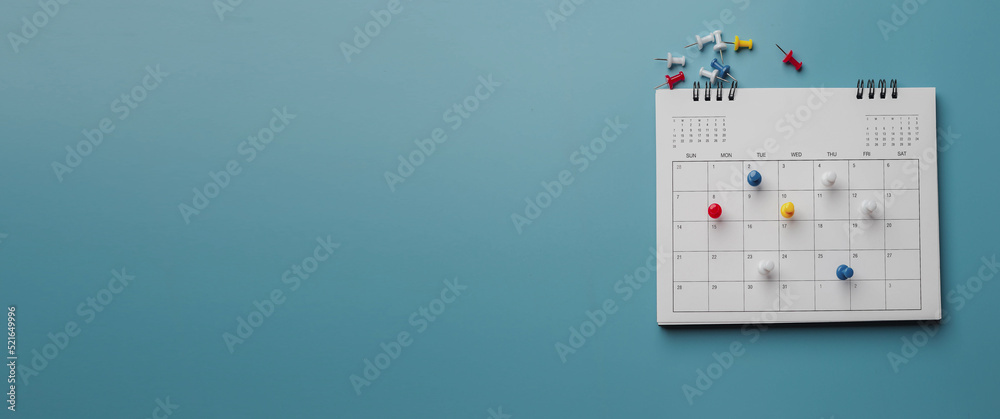 Foto de Stock Embroidered red pins on a calendar event Planner calendar ...