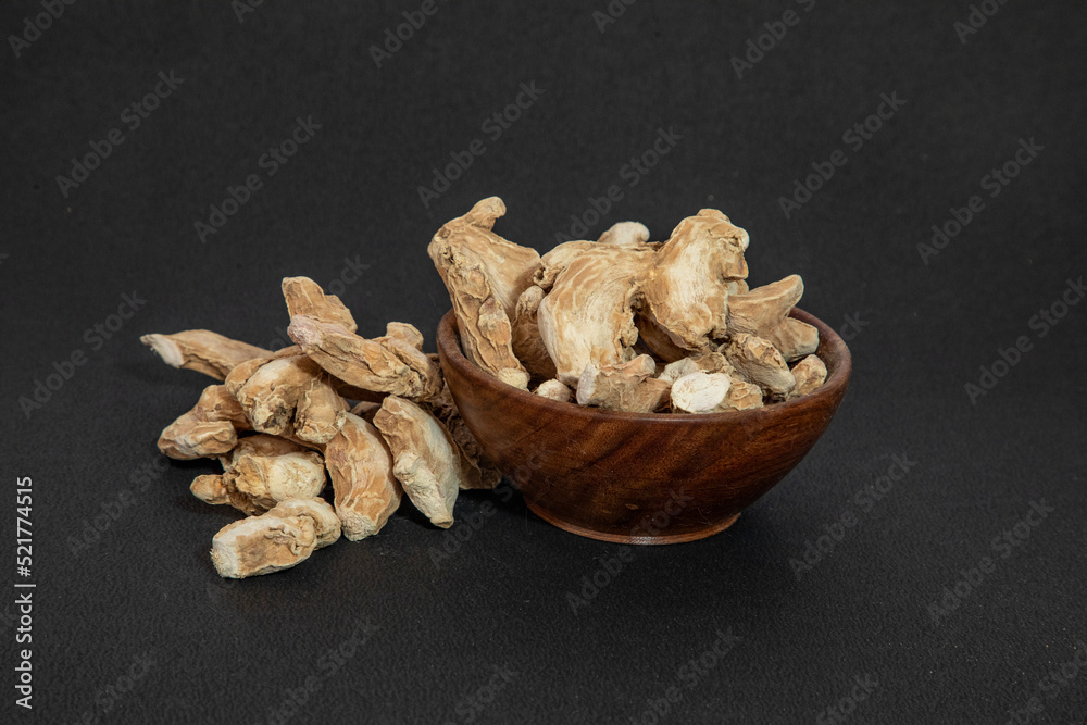 Organic ayurvedic whole dry ginger or sonth adrak on black background ...