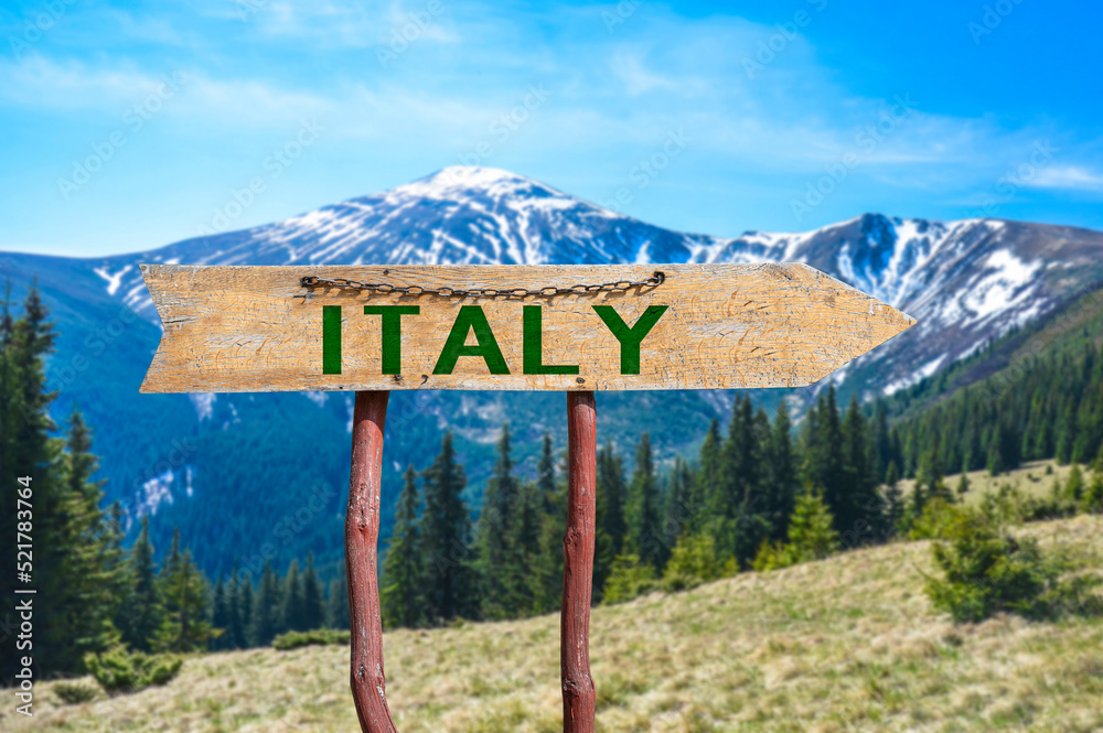 Italy wooden arrow road sign against mountains landscape. Stock Photo ...