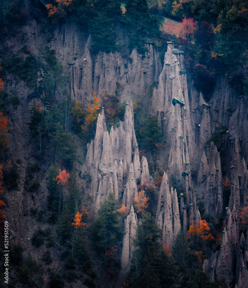 Dark autumn scene of Earth pyramids of Platten - Spiky sand towers ...