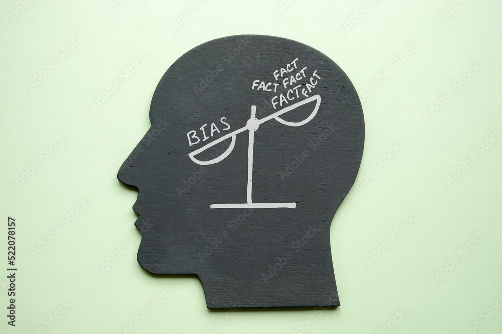 Scales in the head with words bias and facts. Stock Photo | Adobe Stock
