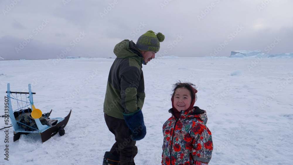 Greenlandic native Inuit father & daughter family enjoy sea ice outing ...