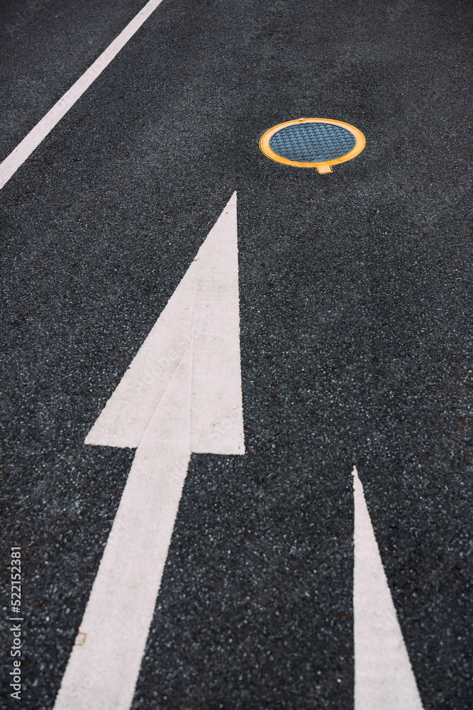 Manhole and road sign Stock Photo | Adobe Stock
