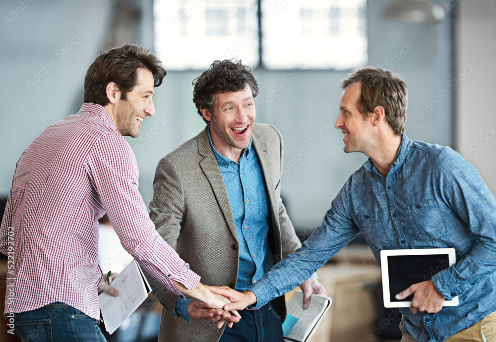 Hands in a huddle as a business man and his colleagues or coworkers ...