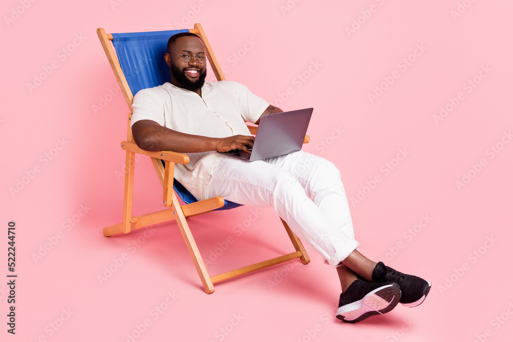 Full length portrait of successful positive man sit chair lounge use ...