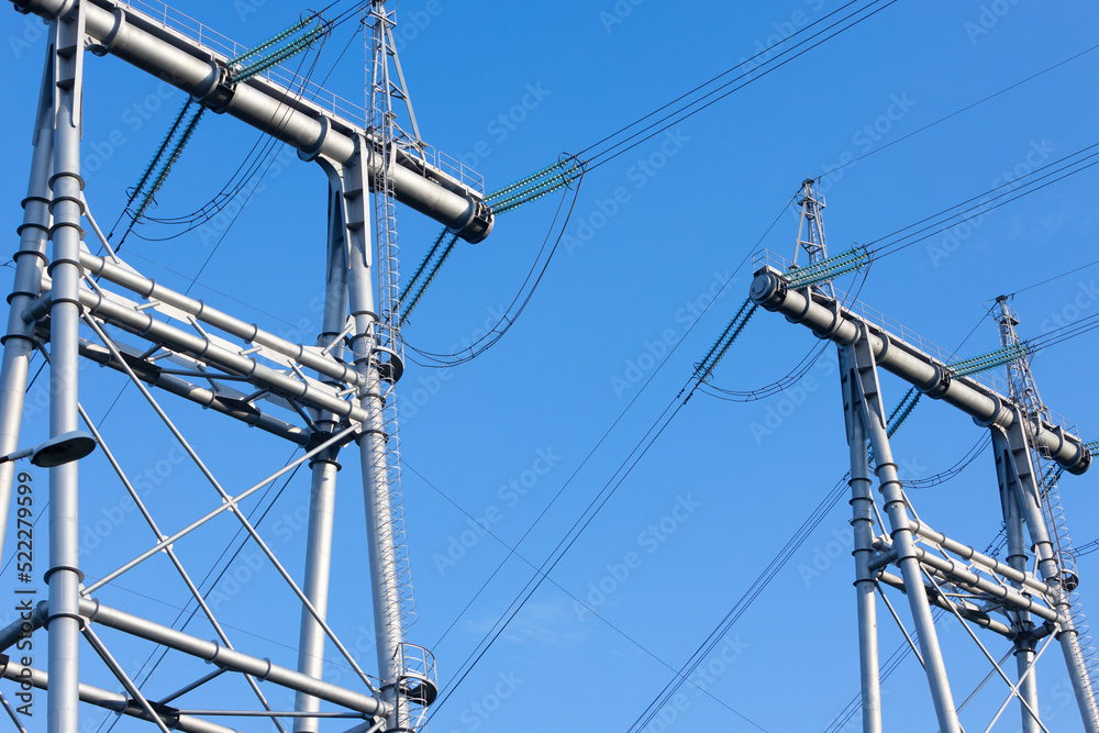 Parallel high voltage posts or power transmission towers with contact ...