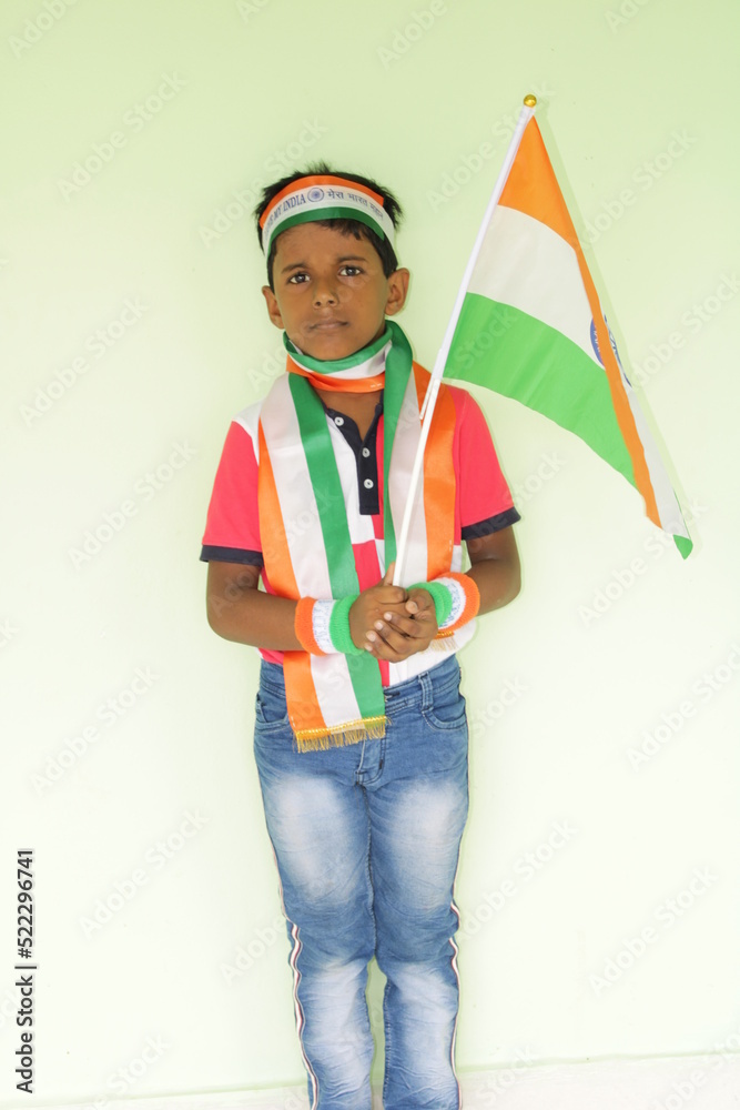 little Boy holding tri colour national Indian flag in the nature ...