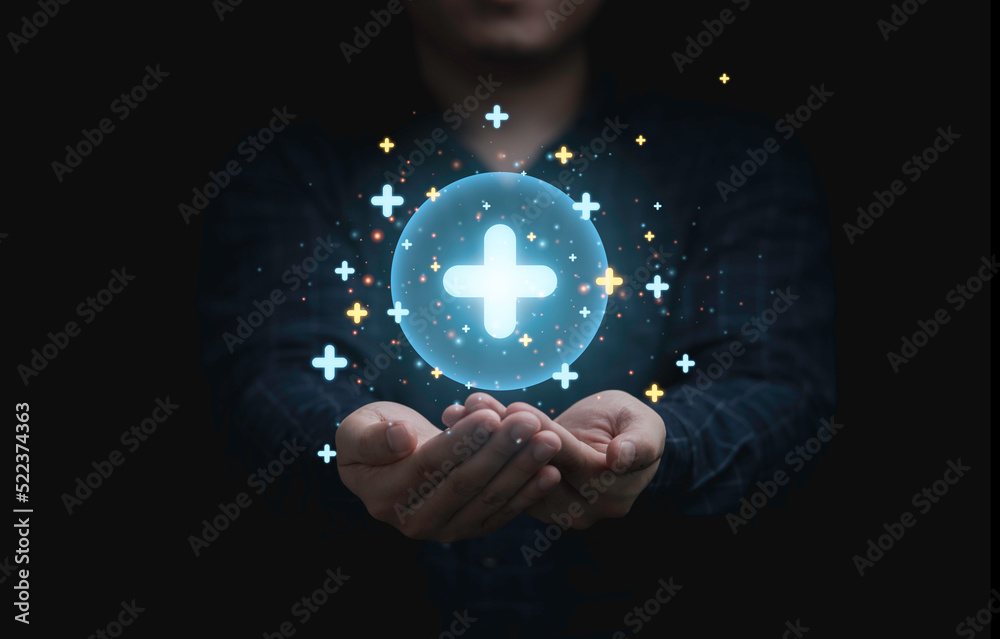 Businessman holding glowing plus sign icon which it symbol of ...
