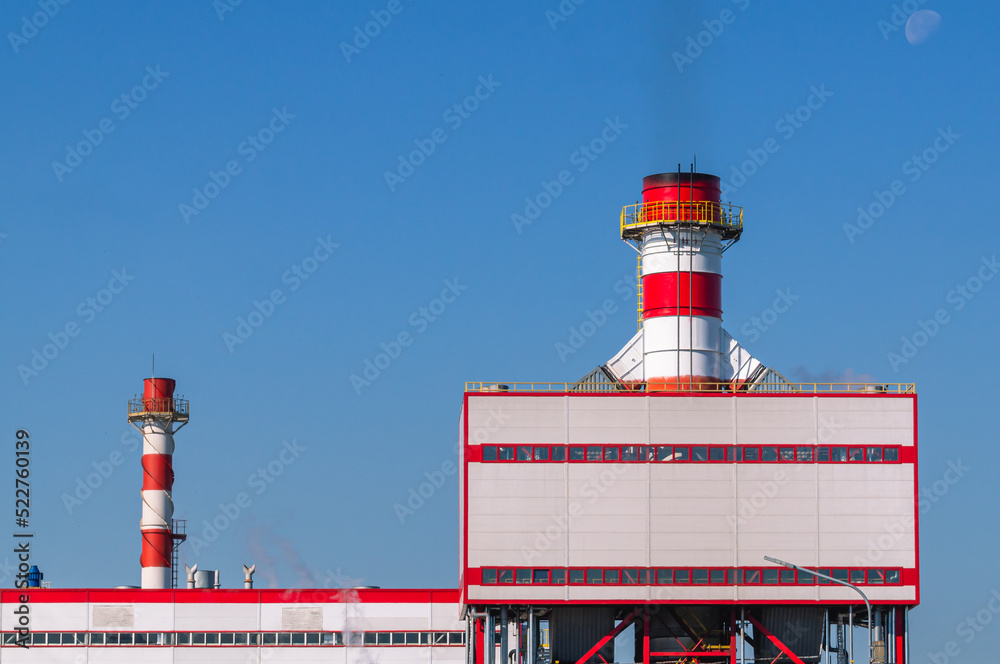 Red and white pipe of a thermal power plant. Conversion of chemical ...