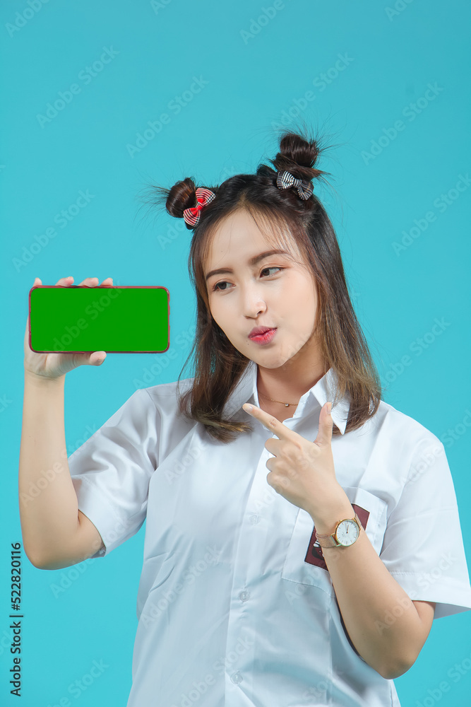 Indonesian female high school students wear gray and white uniforms ...