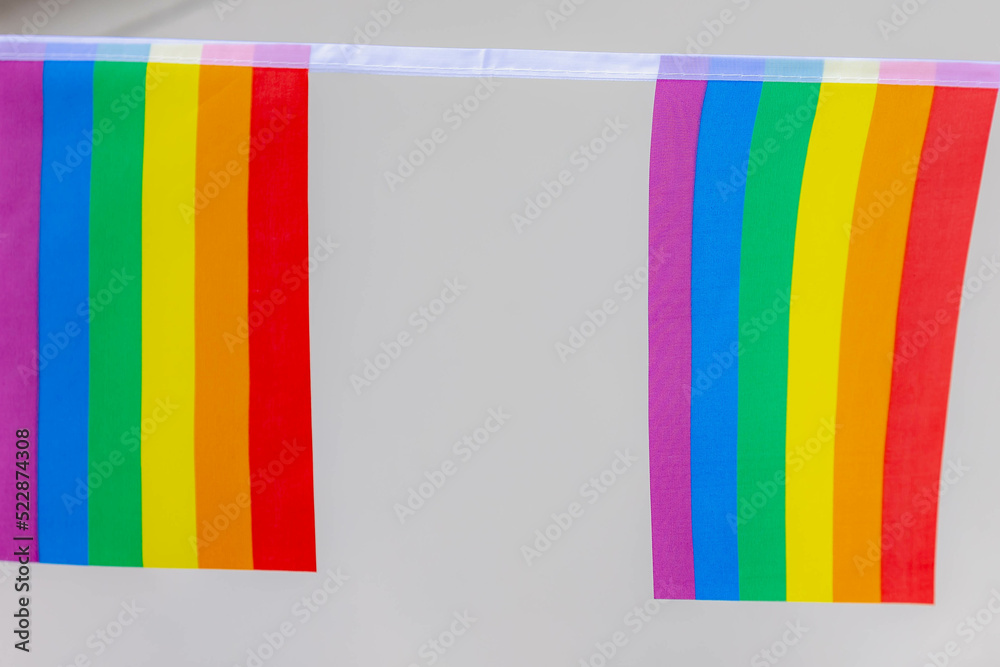 Celebration of pride month, Waving small colourful flags hanging on the ...