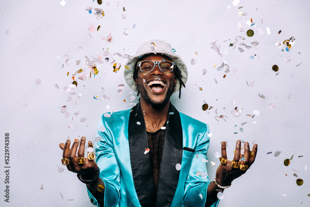 artistic portrait with gel lights. Handsome man posing on colored ...