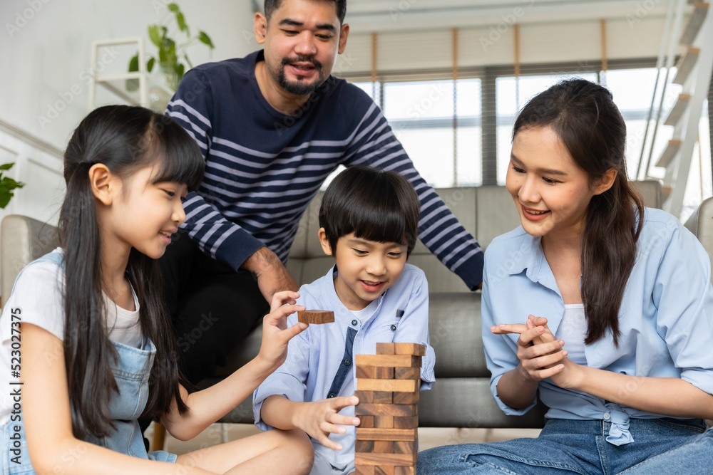 Happy asian family dad and child son building constructor from blocks.Loving parents having fun ...