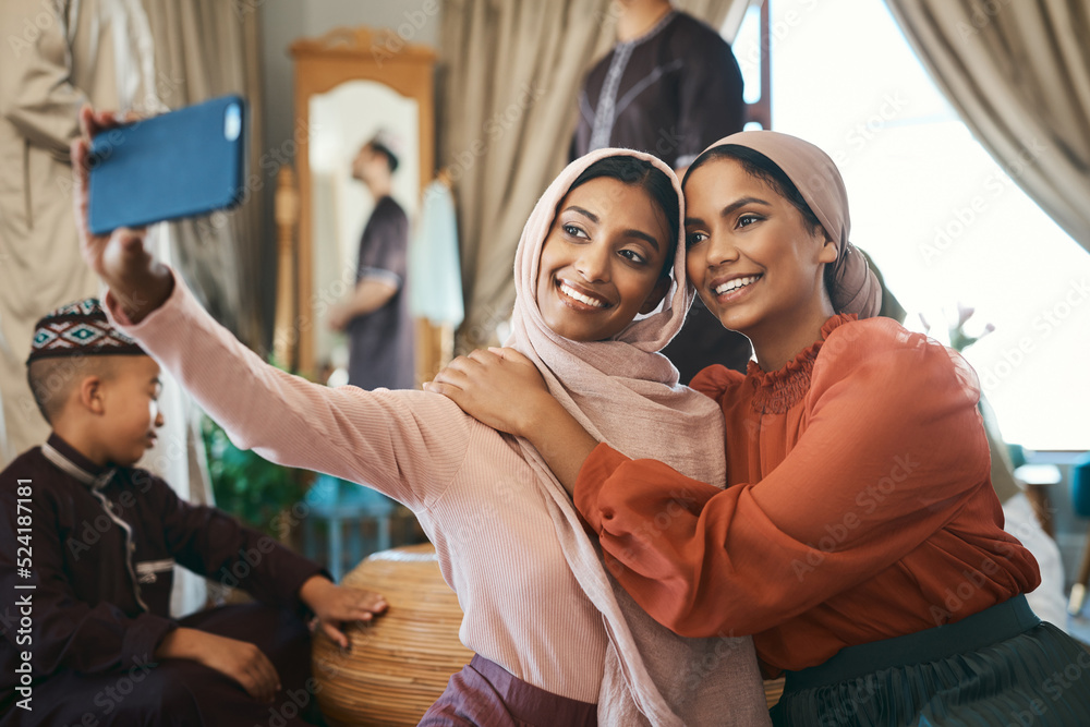 Muslim sisters taking selfies in traditional Islamic head scarf inside ...