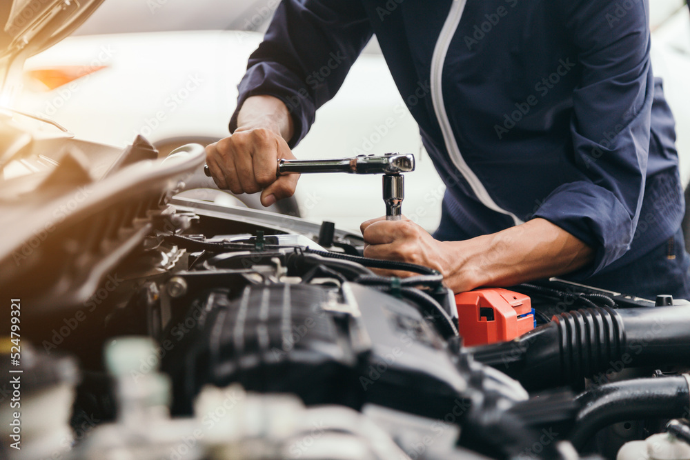 Automobile mechanic repairman hands repairing a car engine automotive ...