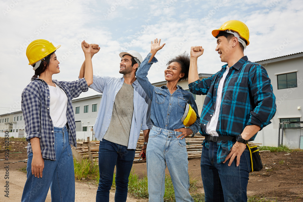 group of workers or architect celebrating success at work and project ...