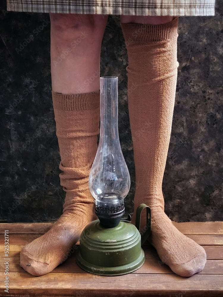 Atmospheric photo of women's legs in vintage knee socks on a wooden ...