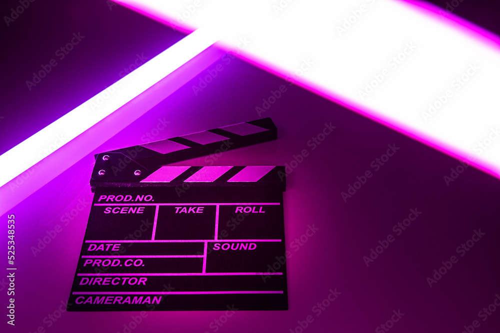 Clapperboard movie slate on Glowing neon lighting background. video ...