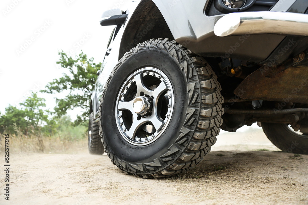 SUV wheel close up is on nature background in summer. mud tire close up ...