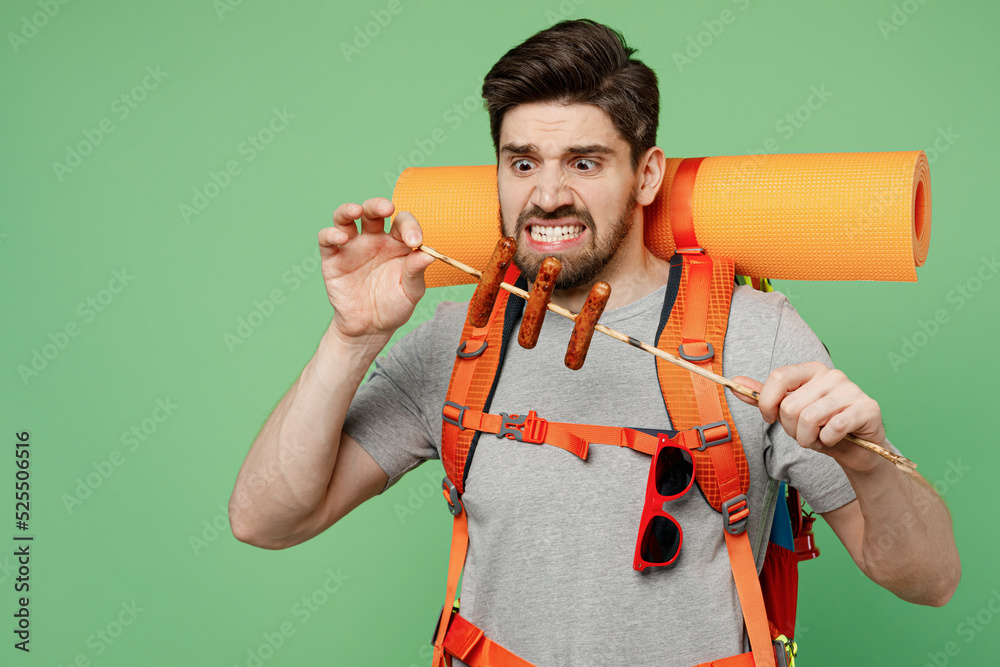 Young sad traveler white man carry backpack stuff hold stick roasted ...