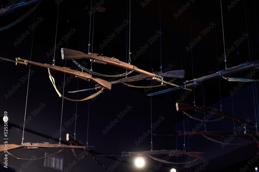 Vintage assault rifle hanging from the ceiling Stock Photo | Adobe Stock