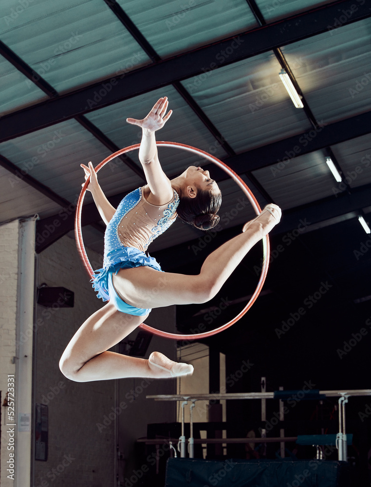 Sports woman, performance and ring in the air for gymnastics show. Fitness girl doing artistic ...