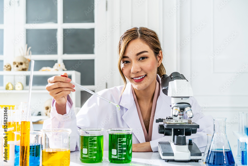 Young asian woman wearing scientist uniform working at scientist ...