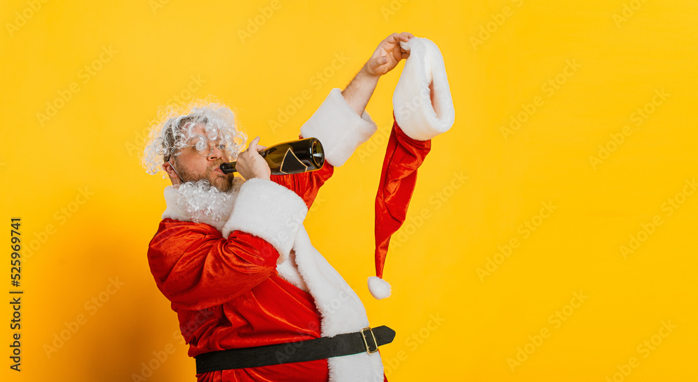 Drunk Santa. Fat santa claus drinks champagne from the neck of a bottle ...